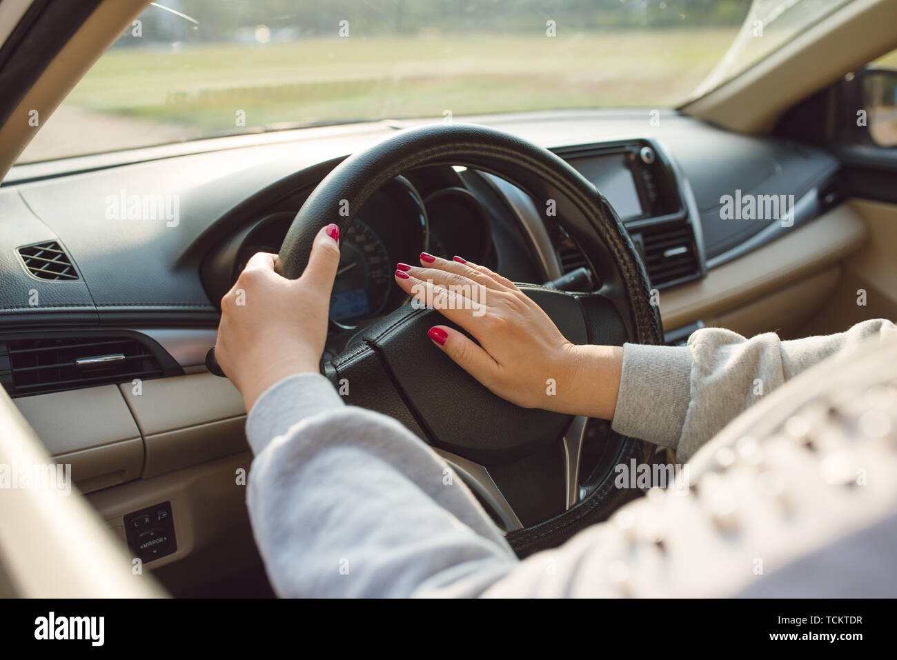 Hand of someone driving car on the road Stock Photo - Alamy
