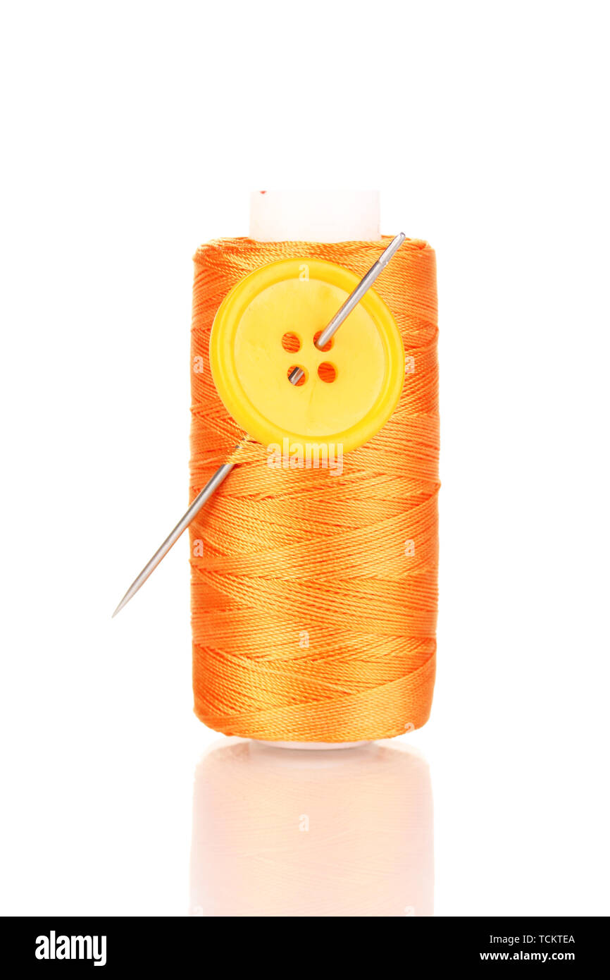 Yellow bobbin with needle and buttons isolated on white Stock Photo - Alamy