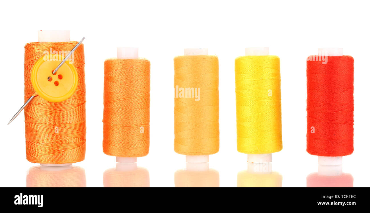 Many yellow bobbin with needle and buttons isolated on white Stock ...