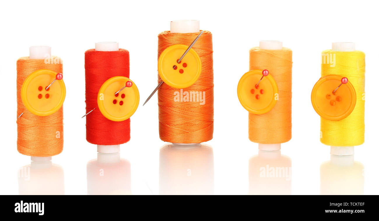 Many yellow bobbin with needle and buttons isolated on white Stock ...