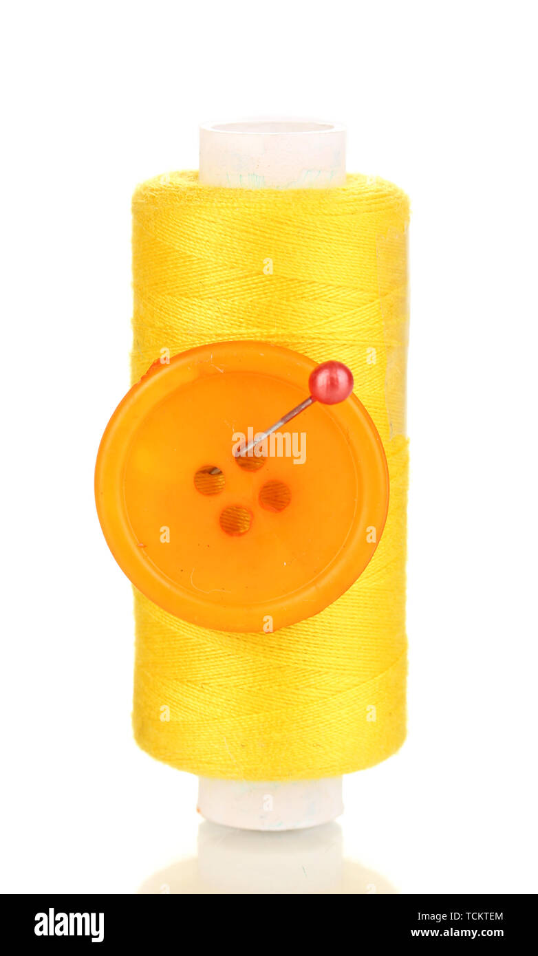 Yellow bobbin with needle and buttons isolated on white Stock Photo - Alamy