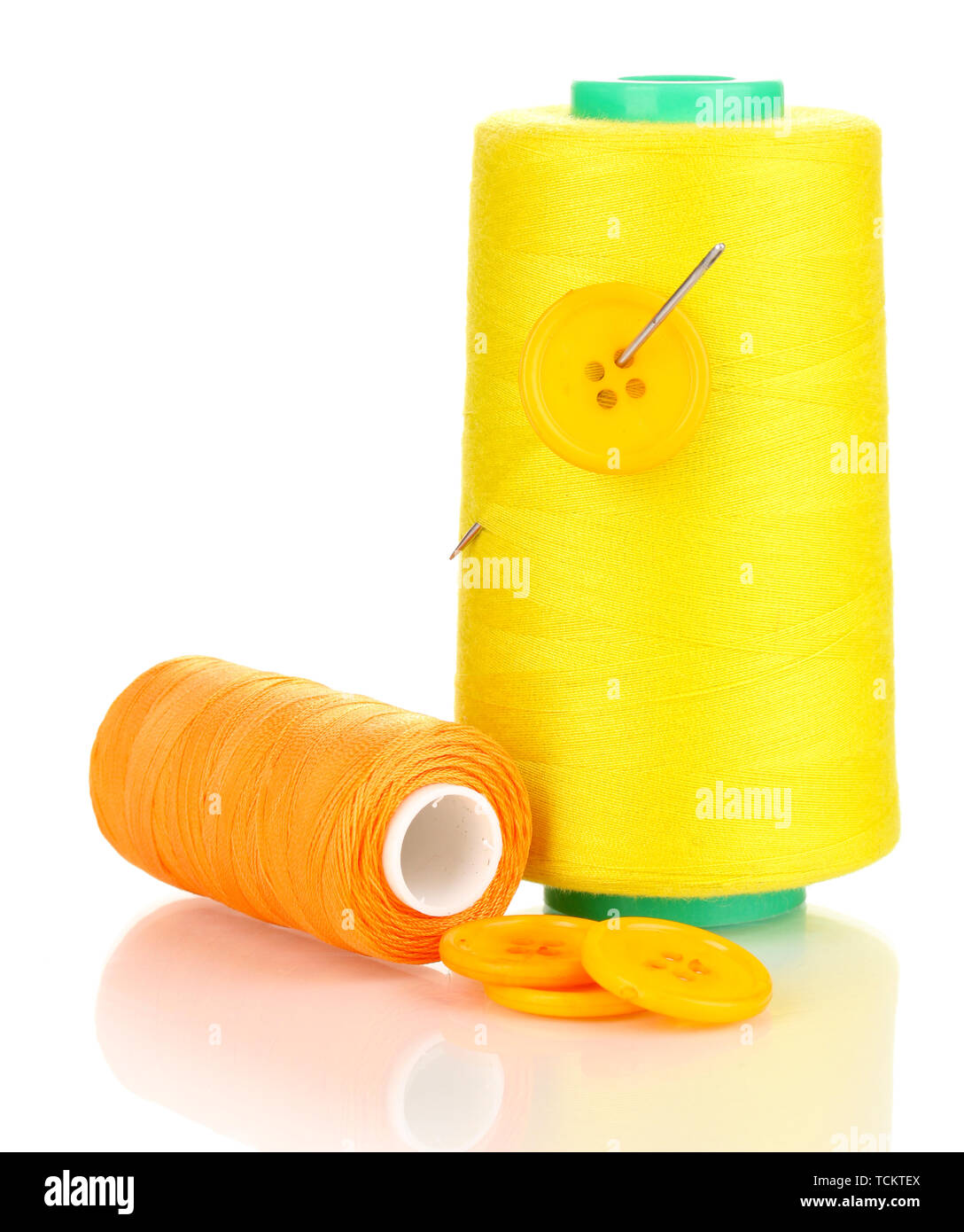 Yellow bobbin with needle and buttons isolated on white Stock Photo - Alamy