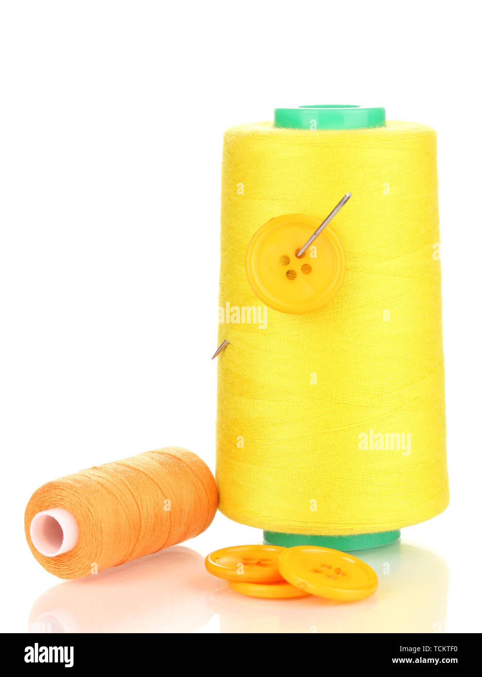 Yellow bobbin with needle and buttons isolated on white Stock Photo - Alamy