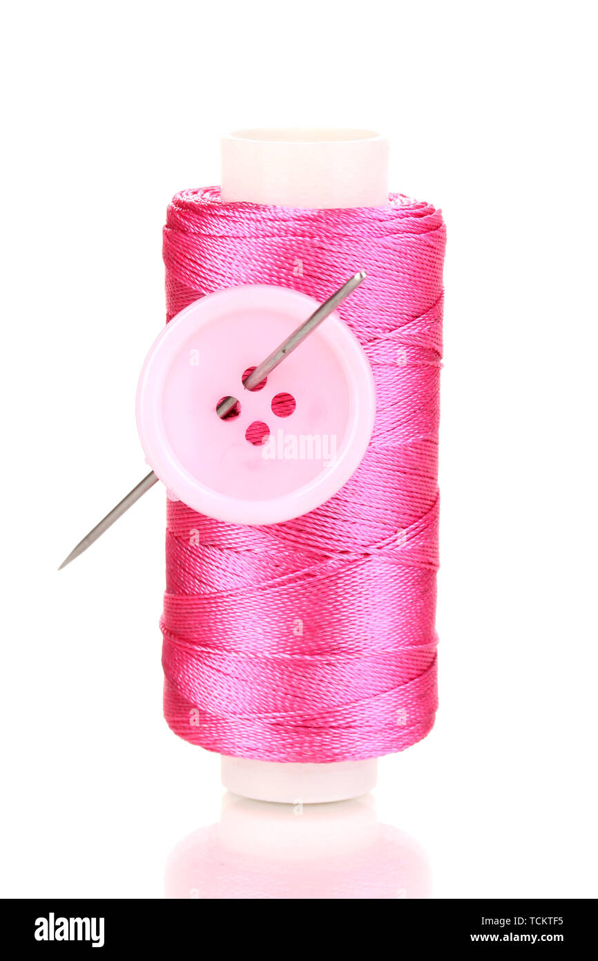 Pink bobbin with needle and buttons isolated on white Stock Photo - Alamy