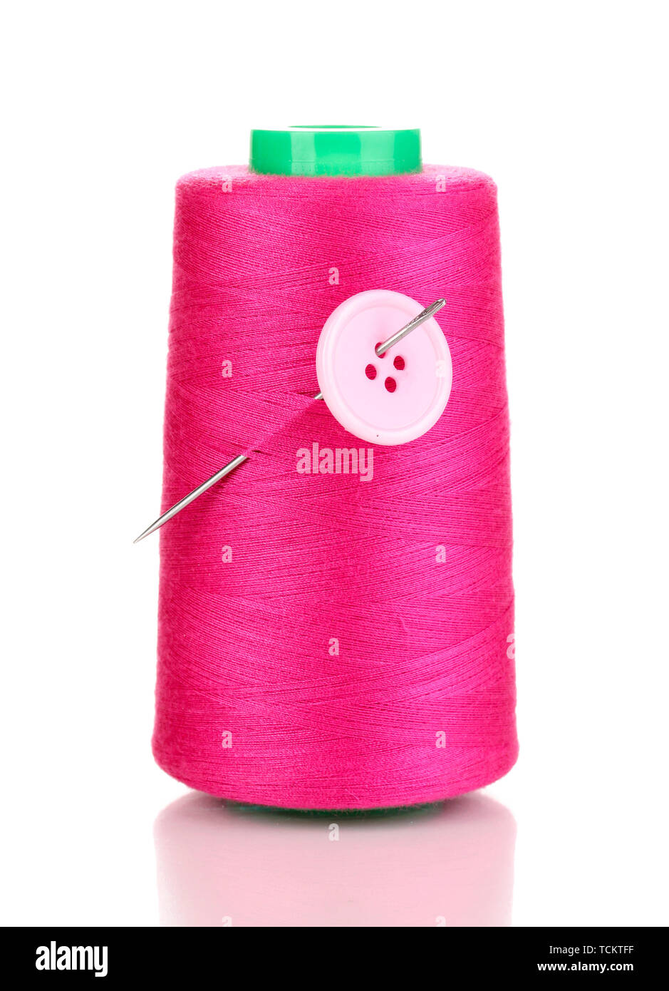 Pink bobbin with needle and buttons isolated on white Stock Photo - Alamy