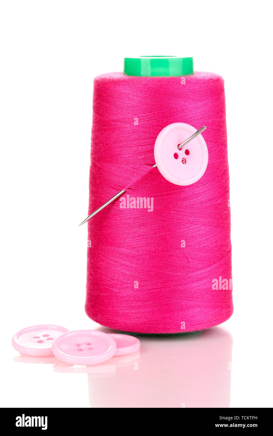 Pink bobbin with needle and buttons isolated on white Stock Photo - Alamy