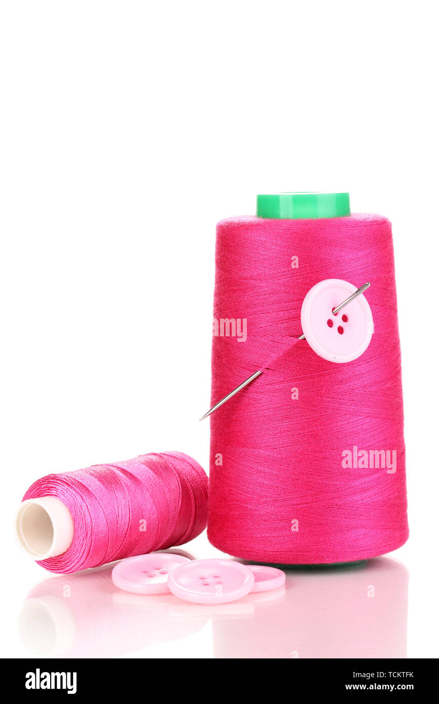 Pink bobbin with needle and buttons isolated on white Stock Photo - Alamy