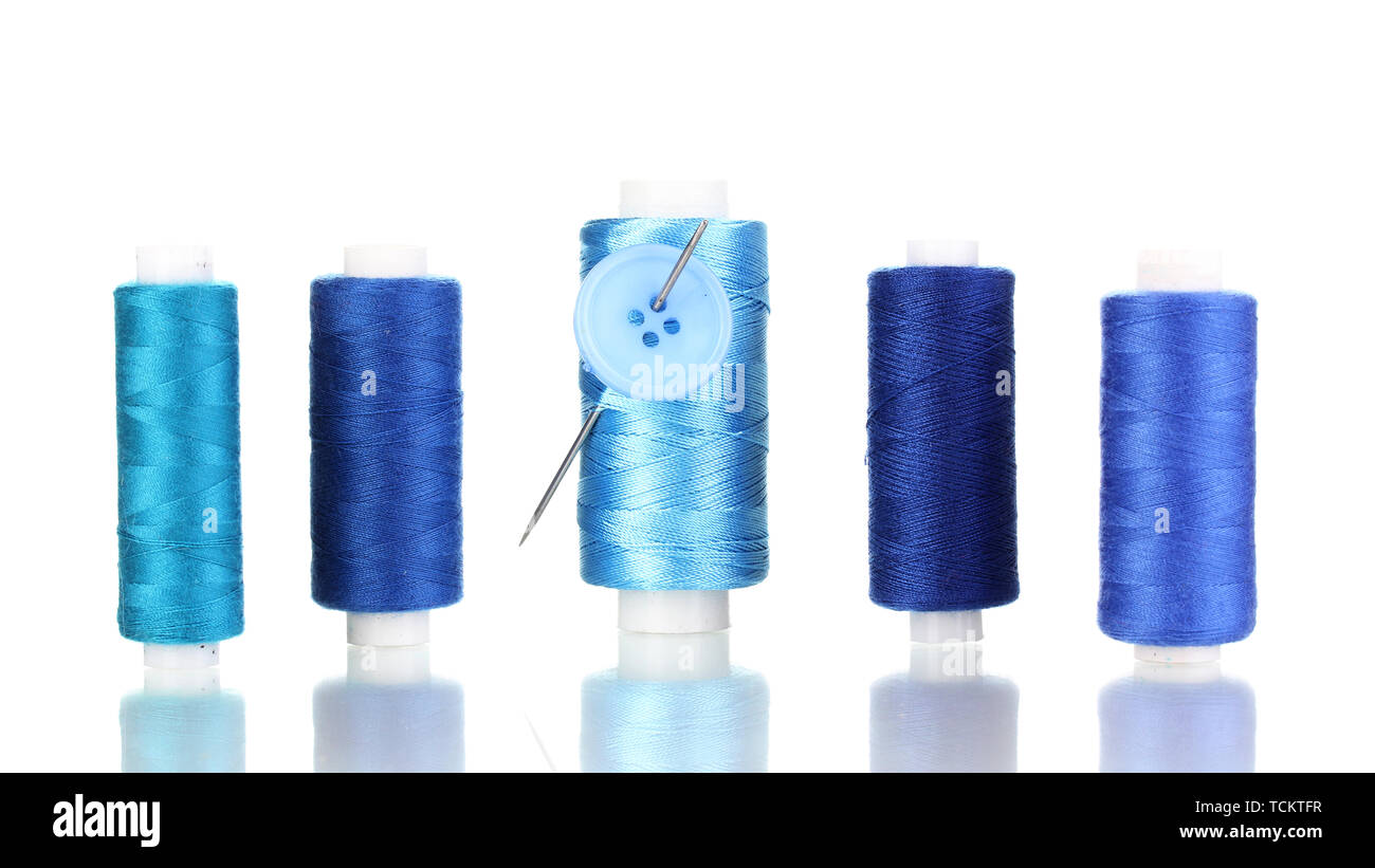 Many blue bobbin with needle and buttons isolated on white Stock Photo ...