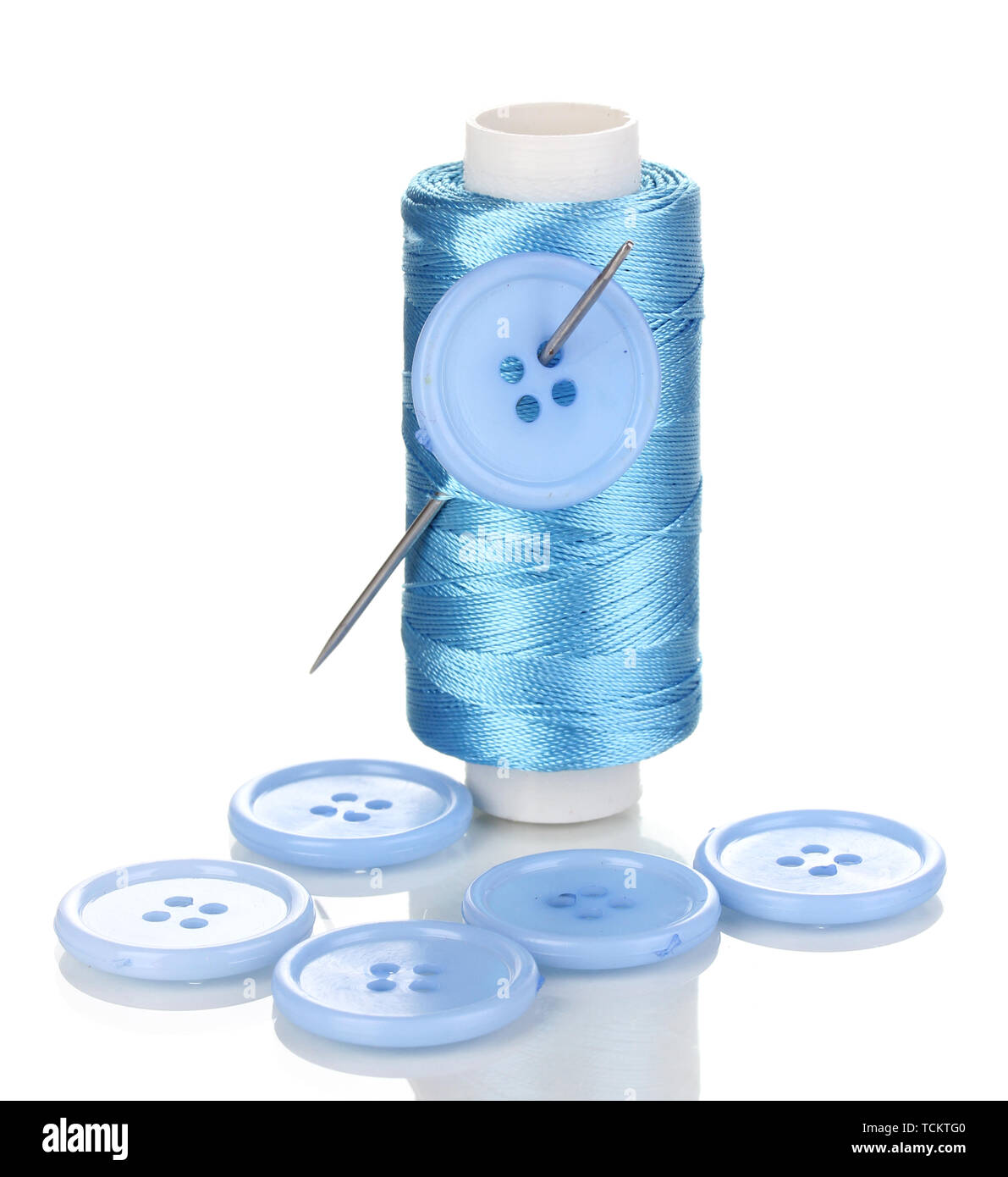 Blue bobbin with needle and buttons isolated on white Stock Photo - Alamy