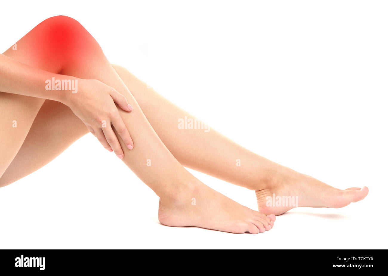 Woman holding sore leg, isolated on white Stock Photo - Alamy