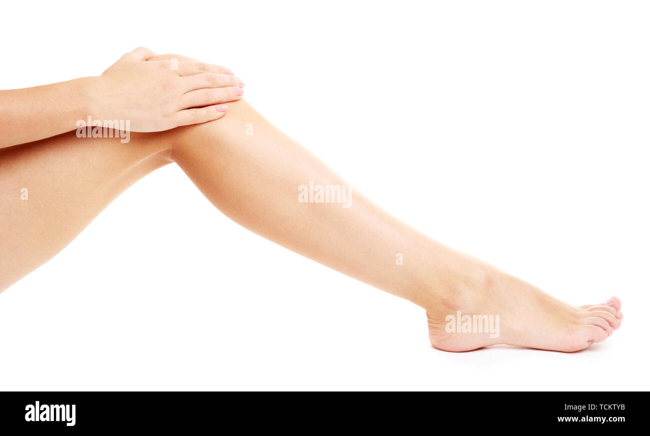 woman holding sore leg, isolated on white Stock Photo - Alamy