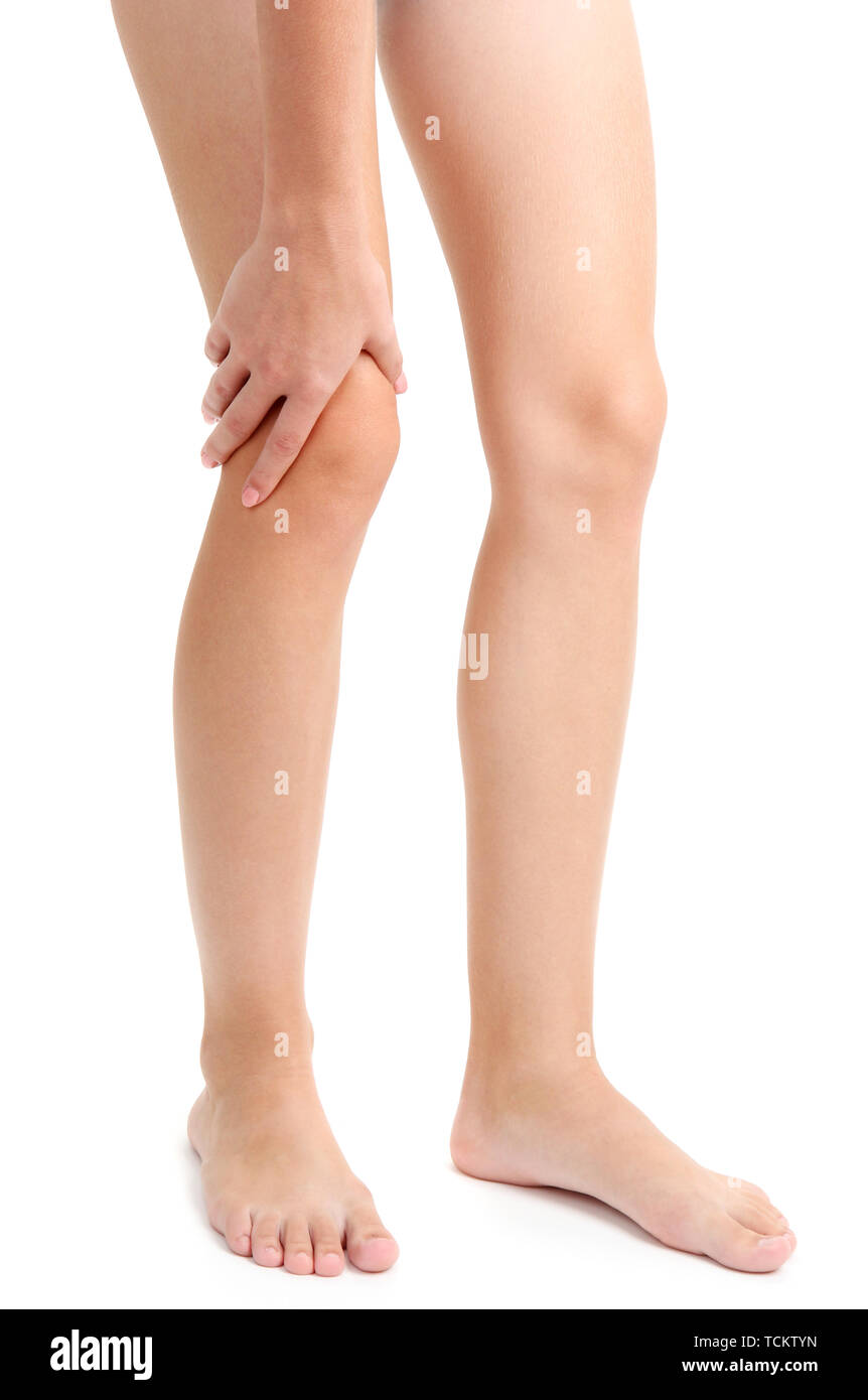 woman holding sore leg, isolated on white Stock Photo - Alamy