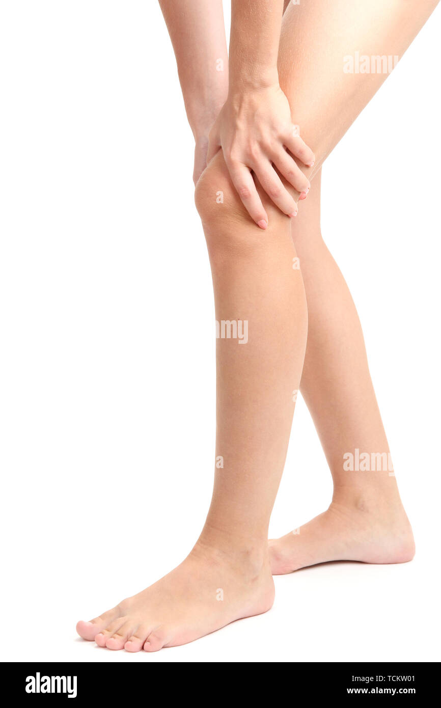 woman holding sore leg, isolated on white Stock Photo - Alamy