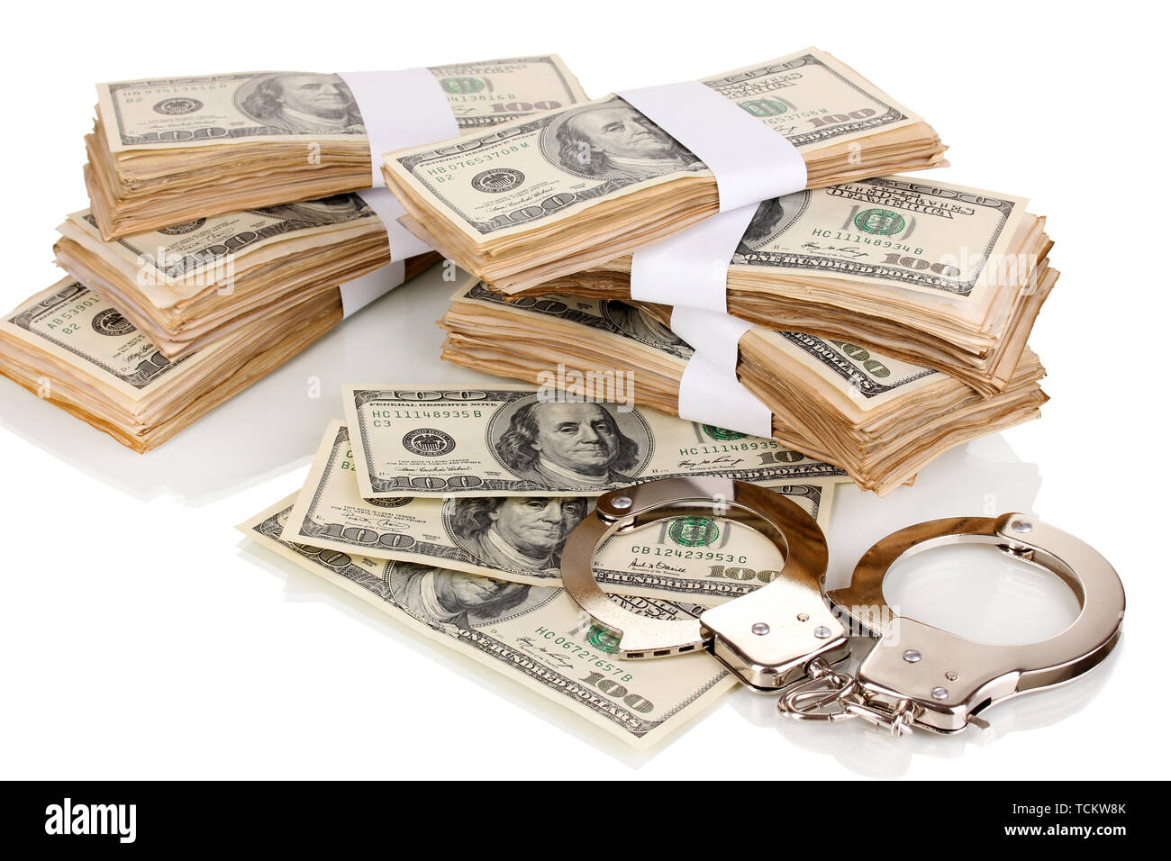 Handcuffs and packs of dollars isolated on white Stock Photo - Alamy