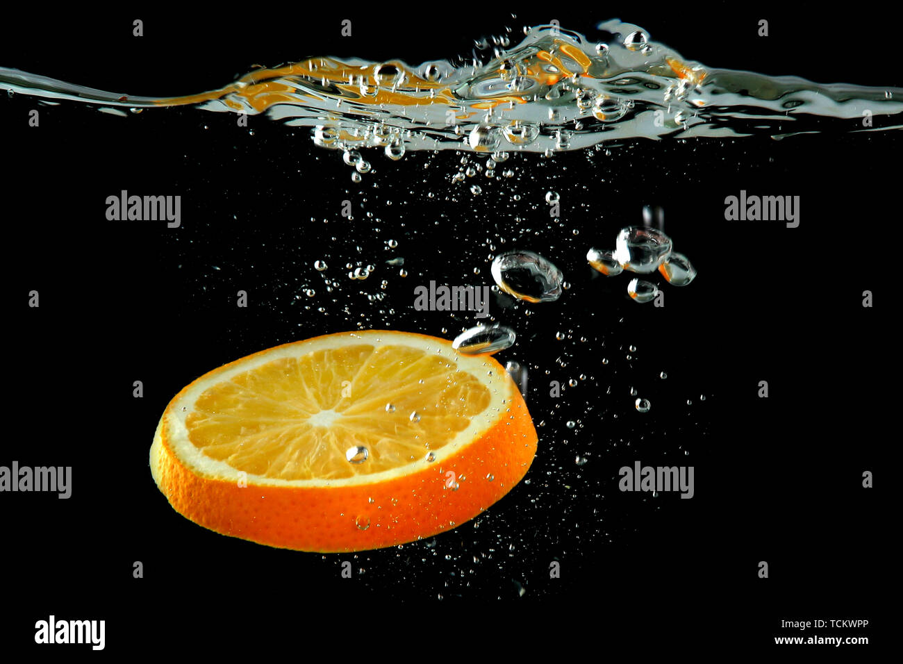 Orange slice splash in transparent hi-res stock photography and images ...