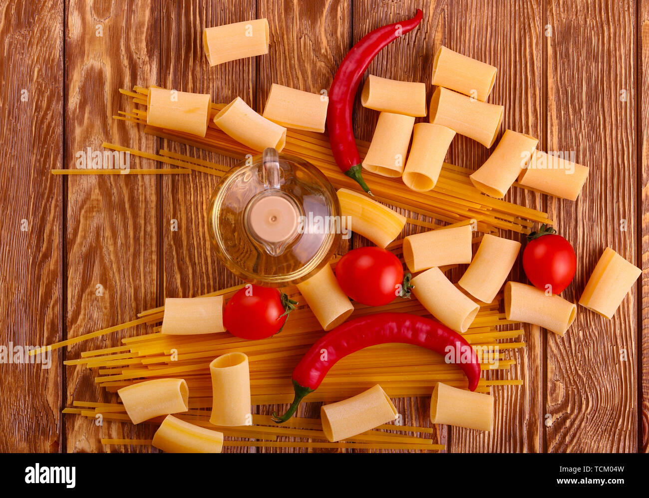 collage Pasta with cherry tomatoes and other ingredients on wooden ...