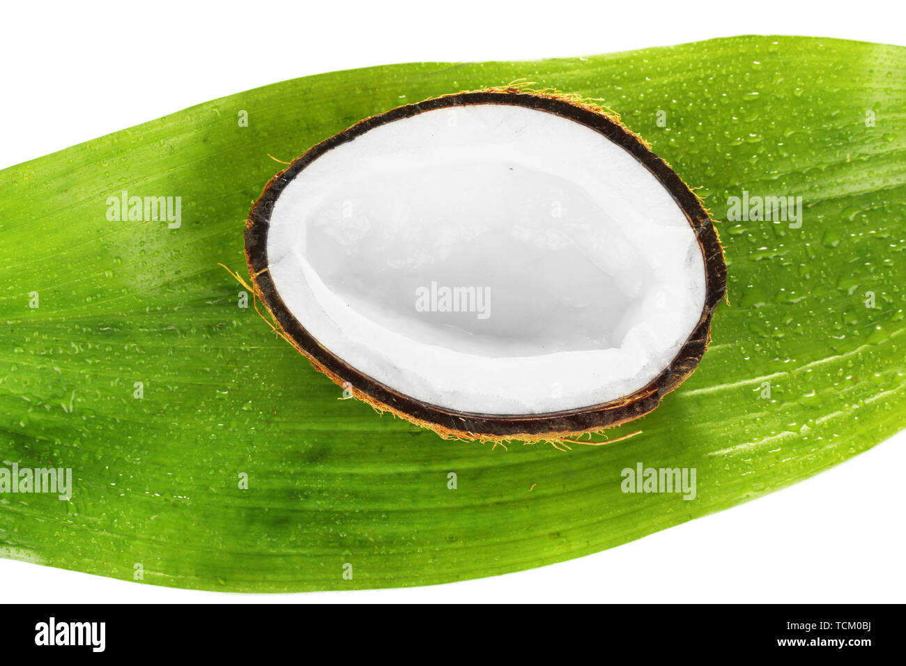 half coconut with green leaf on white background close-up Stock Photo ...