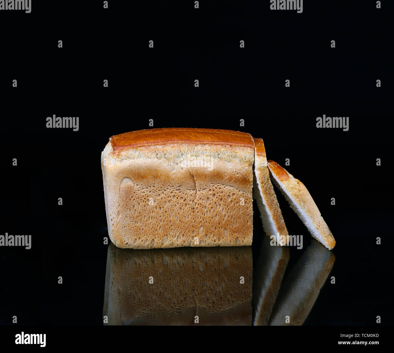 Bread on a black background with reflection Stock Photo - Alamy