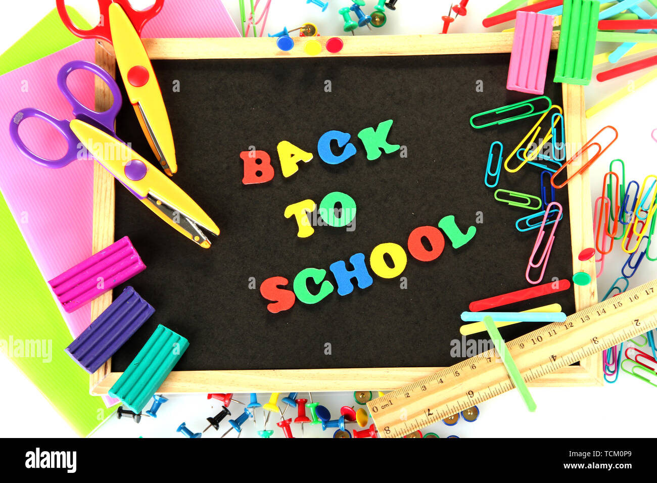 Small chalkboard with school supplies on white background. Back to ...