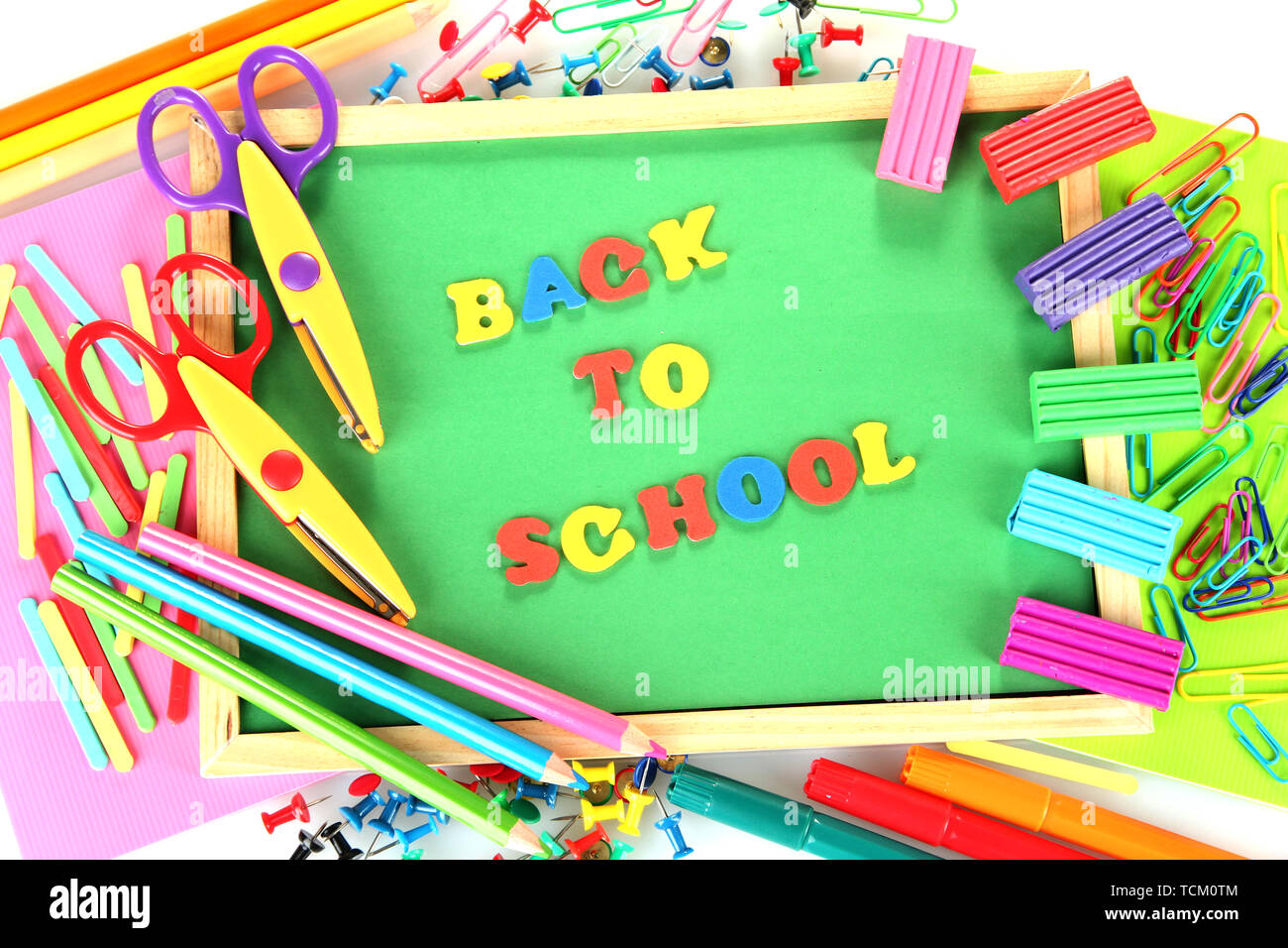 Small chalkboard with school supplies on white background. Back to ...