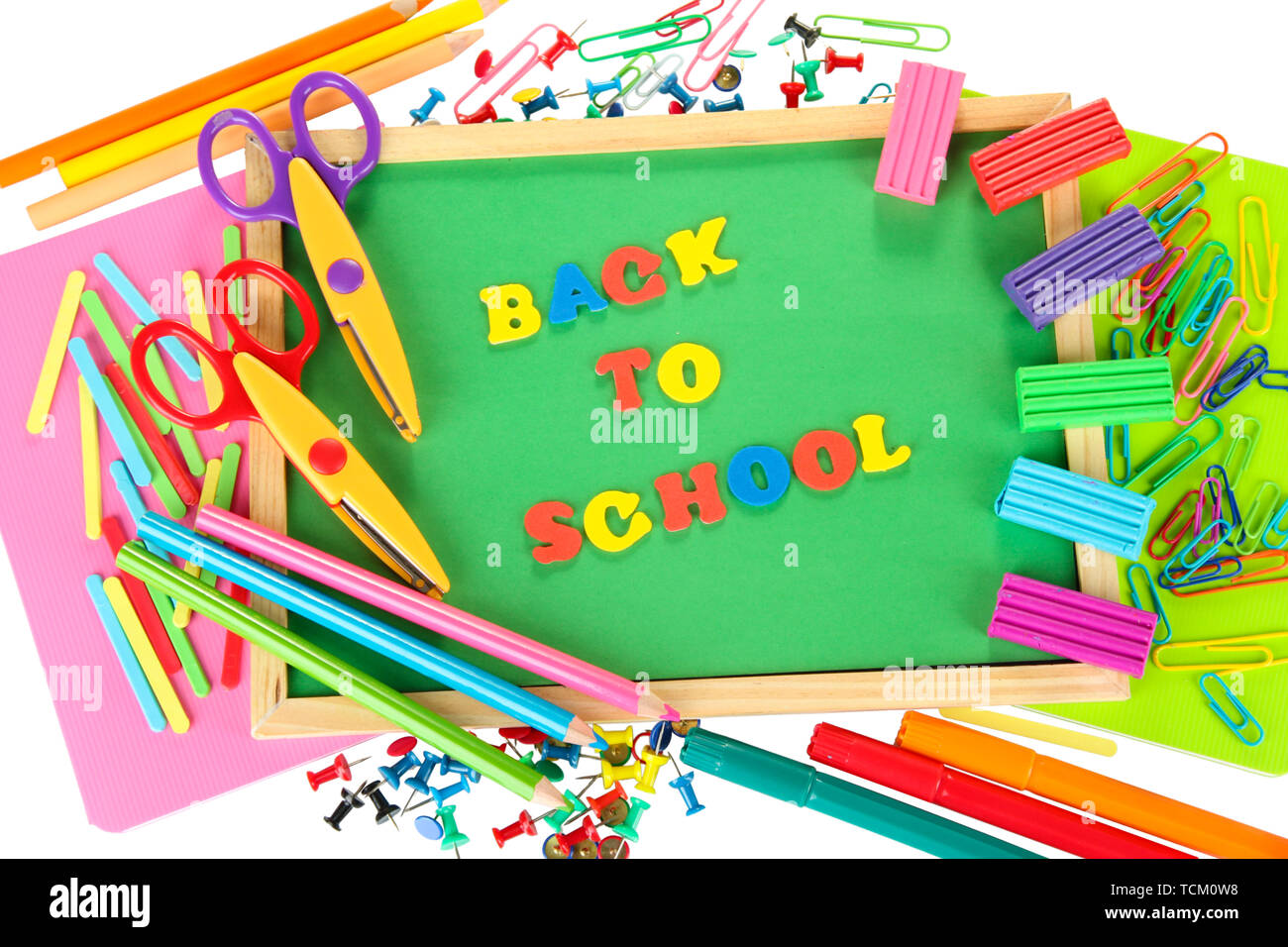 Small chalkboard with school supplies on white background. Back to ...