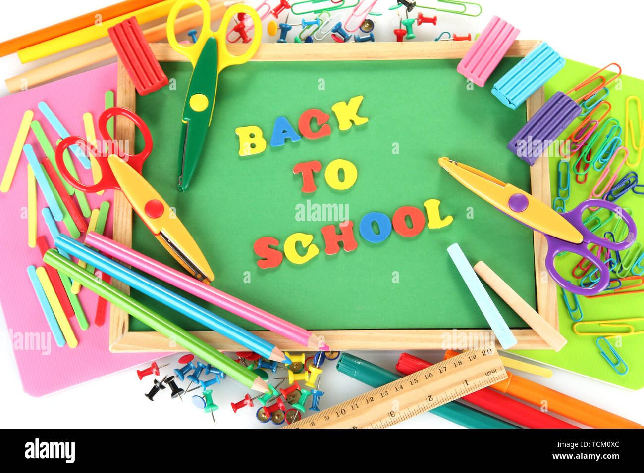 Small chalkboard with school supplies on white background. Back to ...