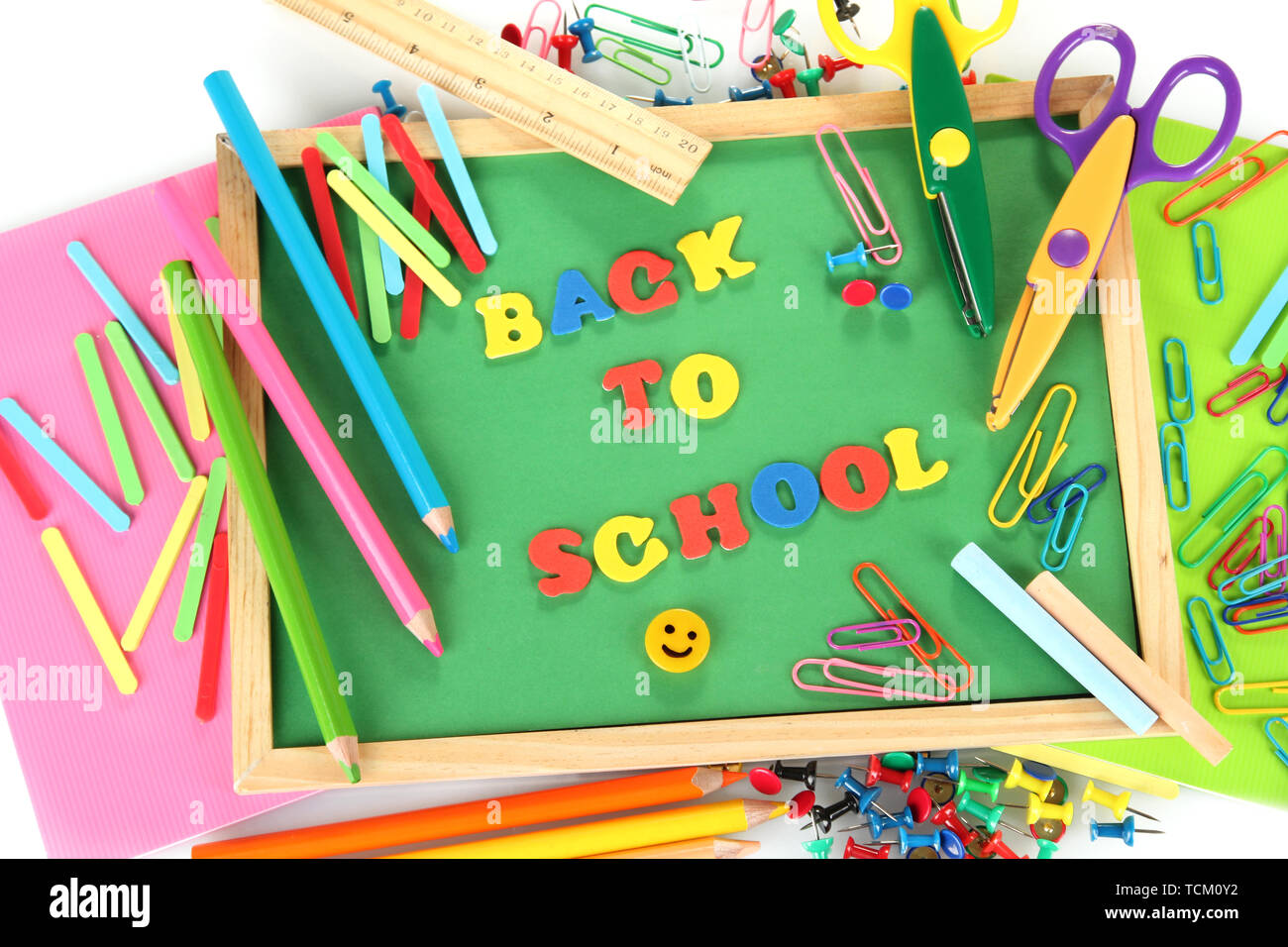 Small chalkboard with school supplies on white background. Back to ...