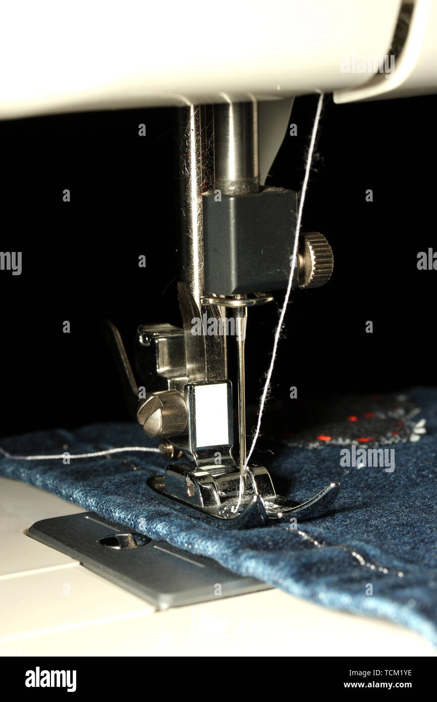 Sewing machine with jeans closeup Stock Photo - Alamy