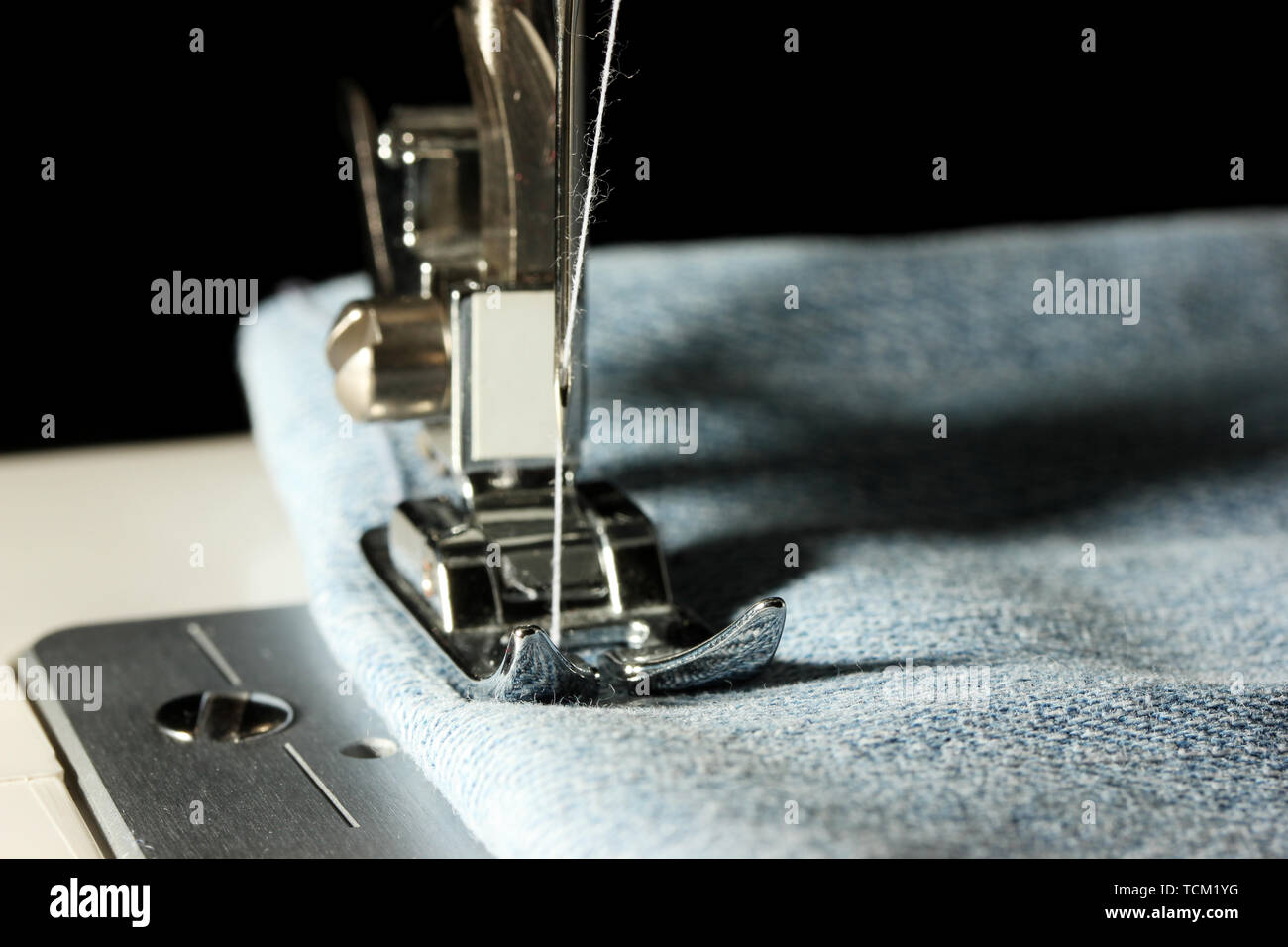 Sewing machine with jeans closeup Stock Photo - Alamy