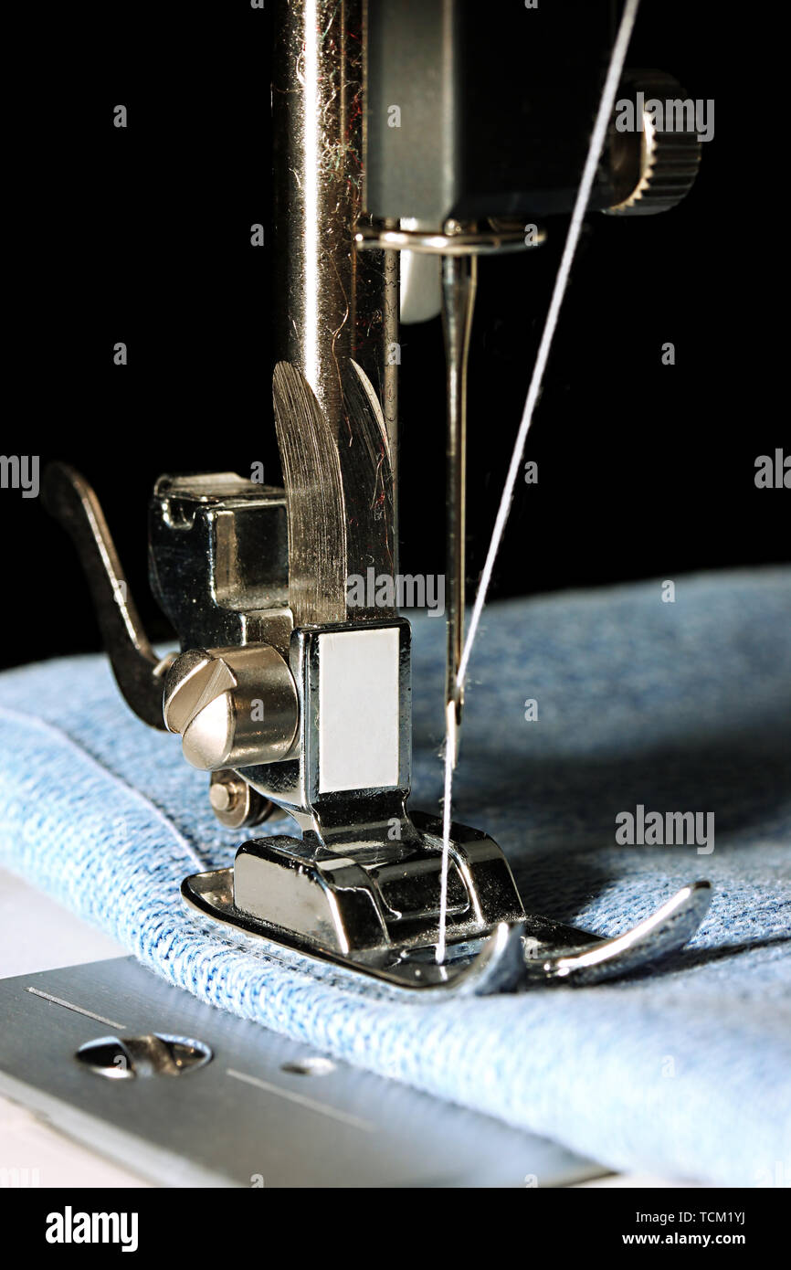 Sewing machine with jeans closeup Stock Photo - Alamy
