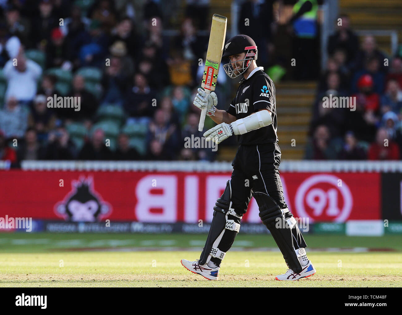 New Zealand's Kane Williamson raises his bat after reaching his half ...