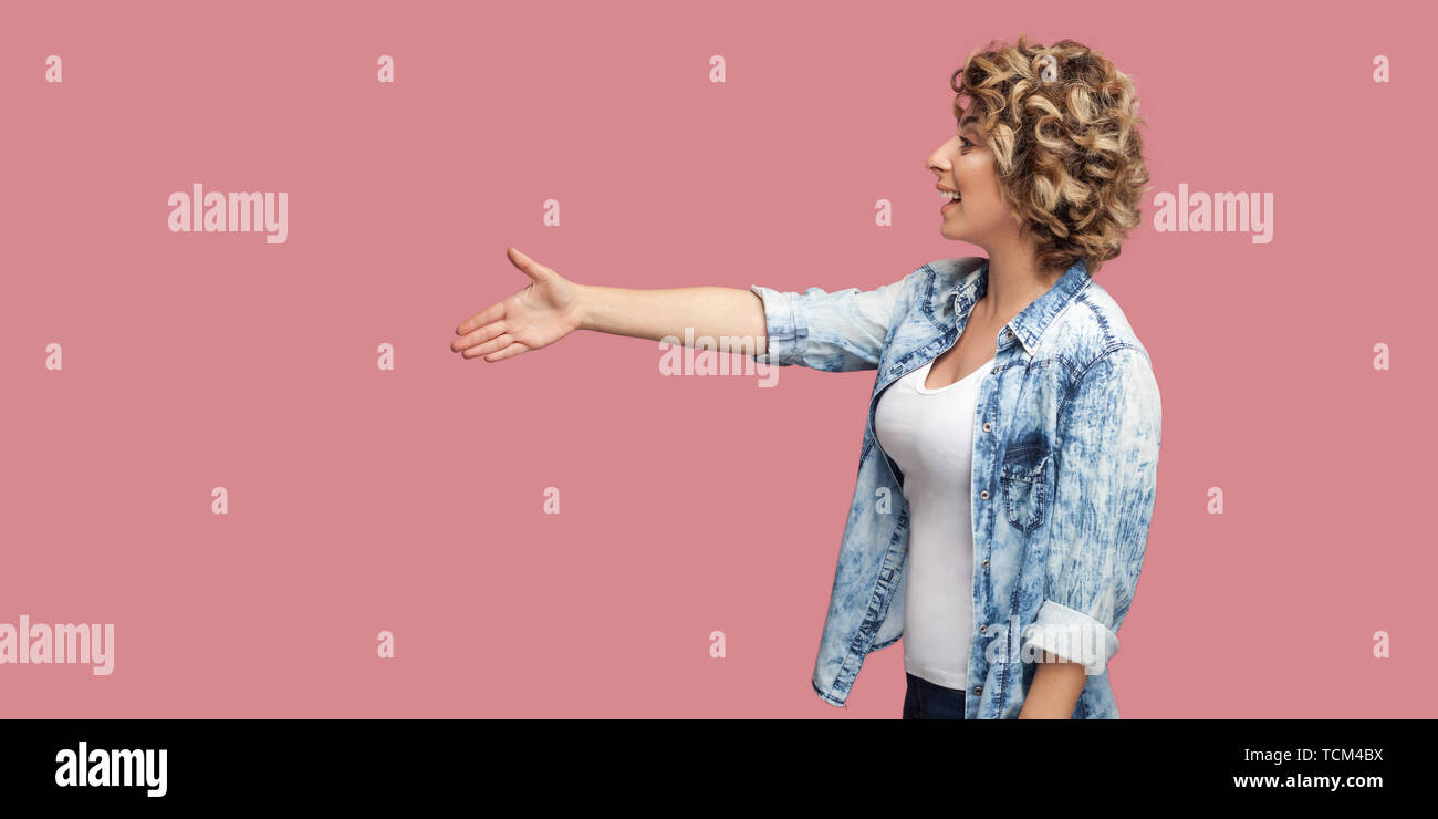 Profile side view portrait of happy young curly woman in casual blue ...