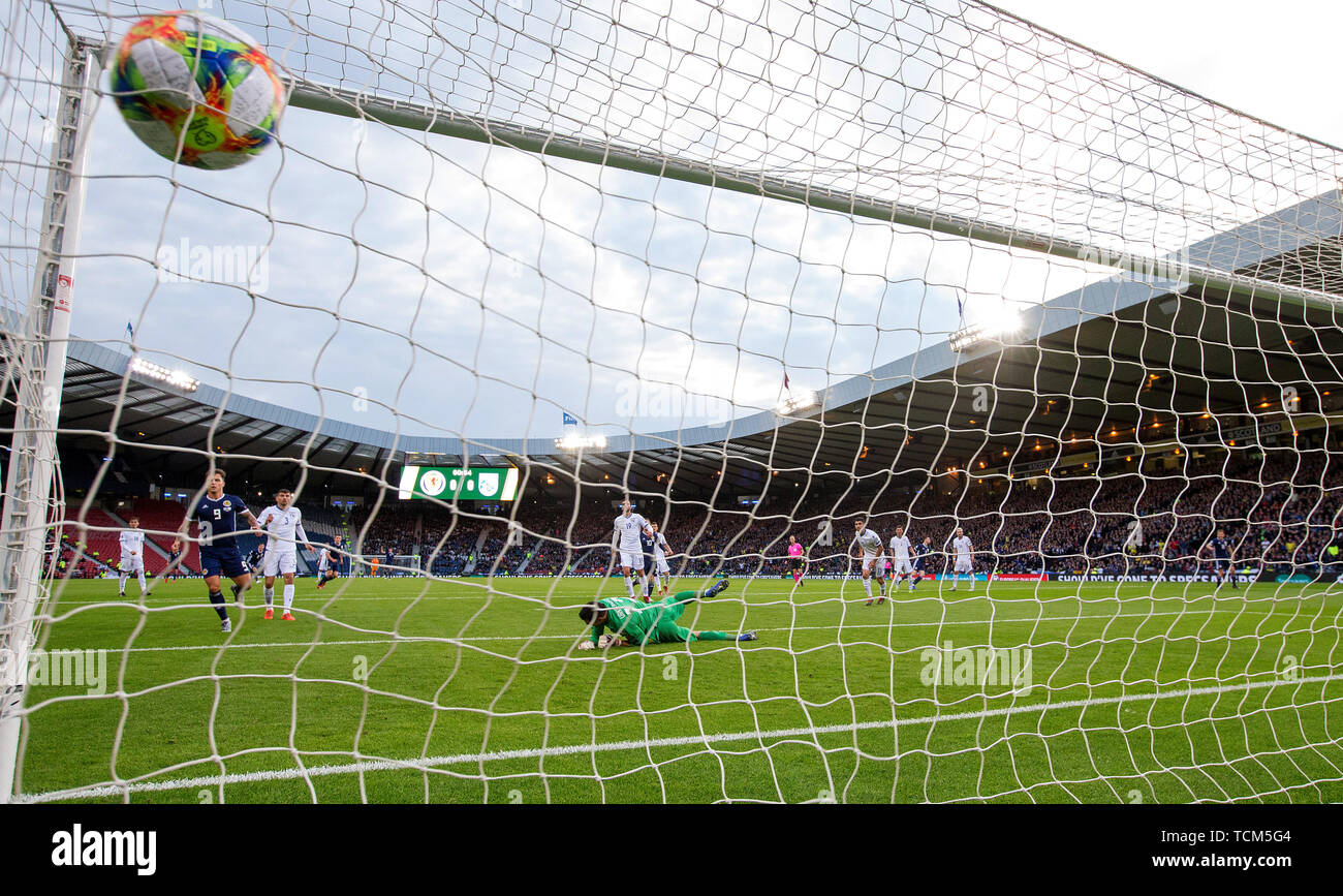 Scotland's Andy Robertson (second right) scores his side's first goal ...
