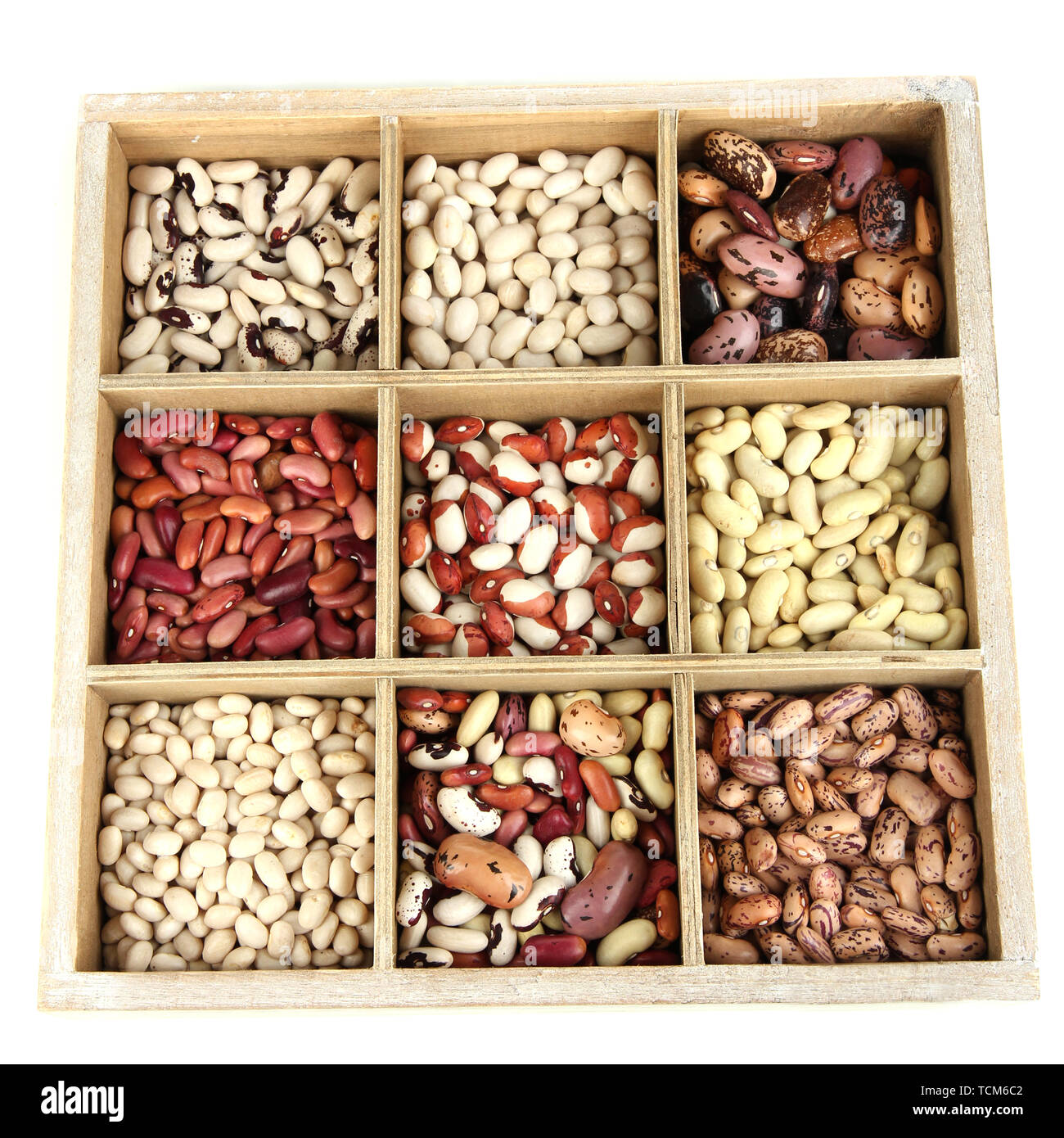 Diverse beans in wooden box sections isolated on white Stock Photo - Alamy