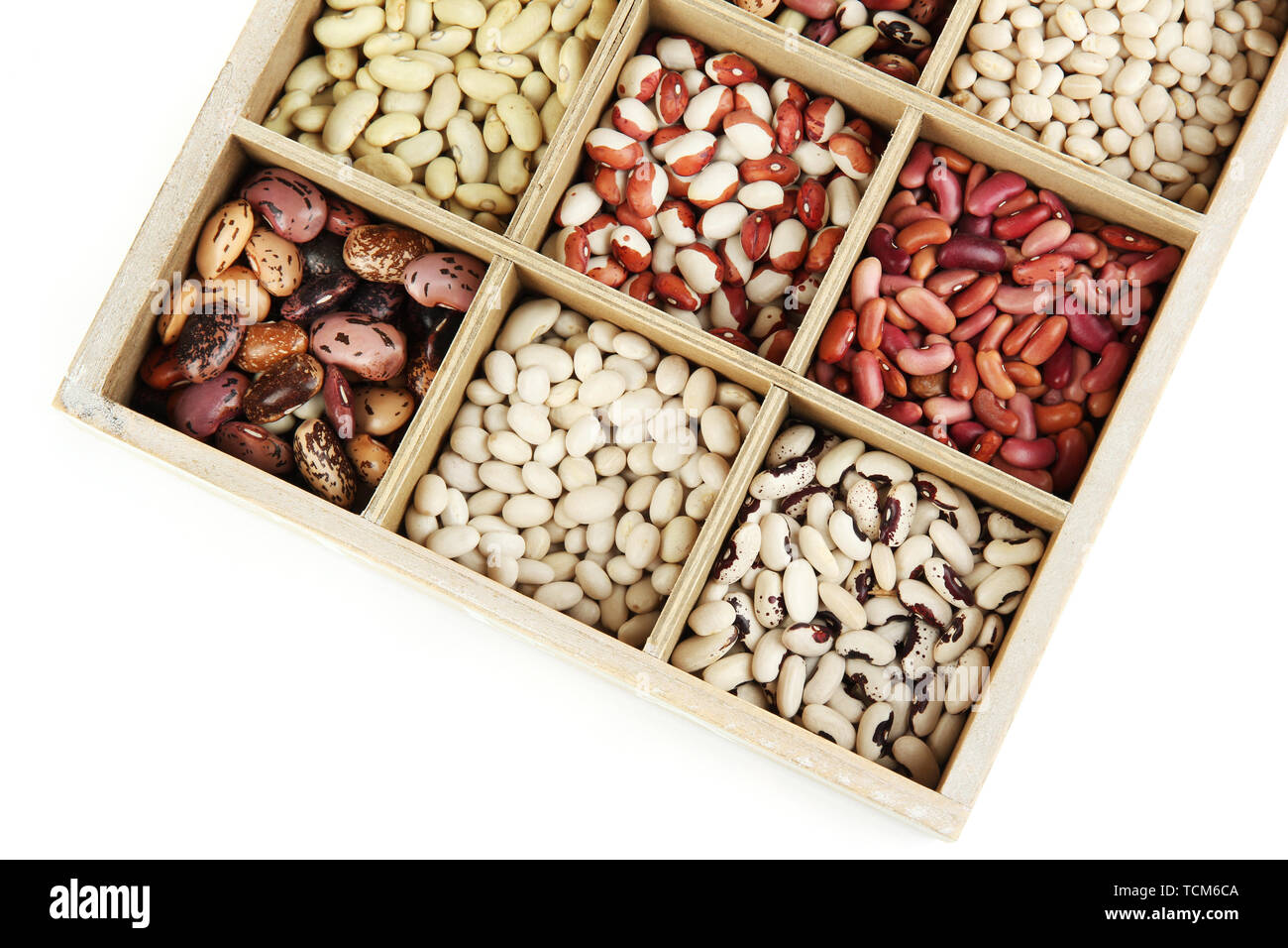 Diverse beans in wooden box sections isolated on white Stock Photo - Alamy