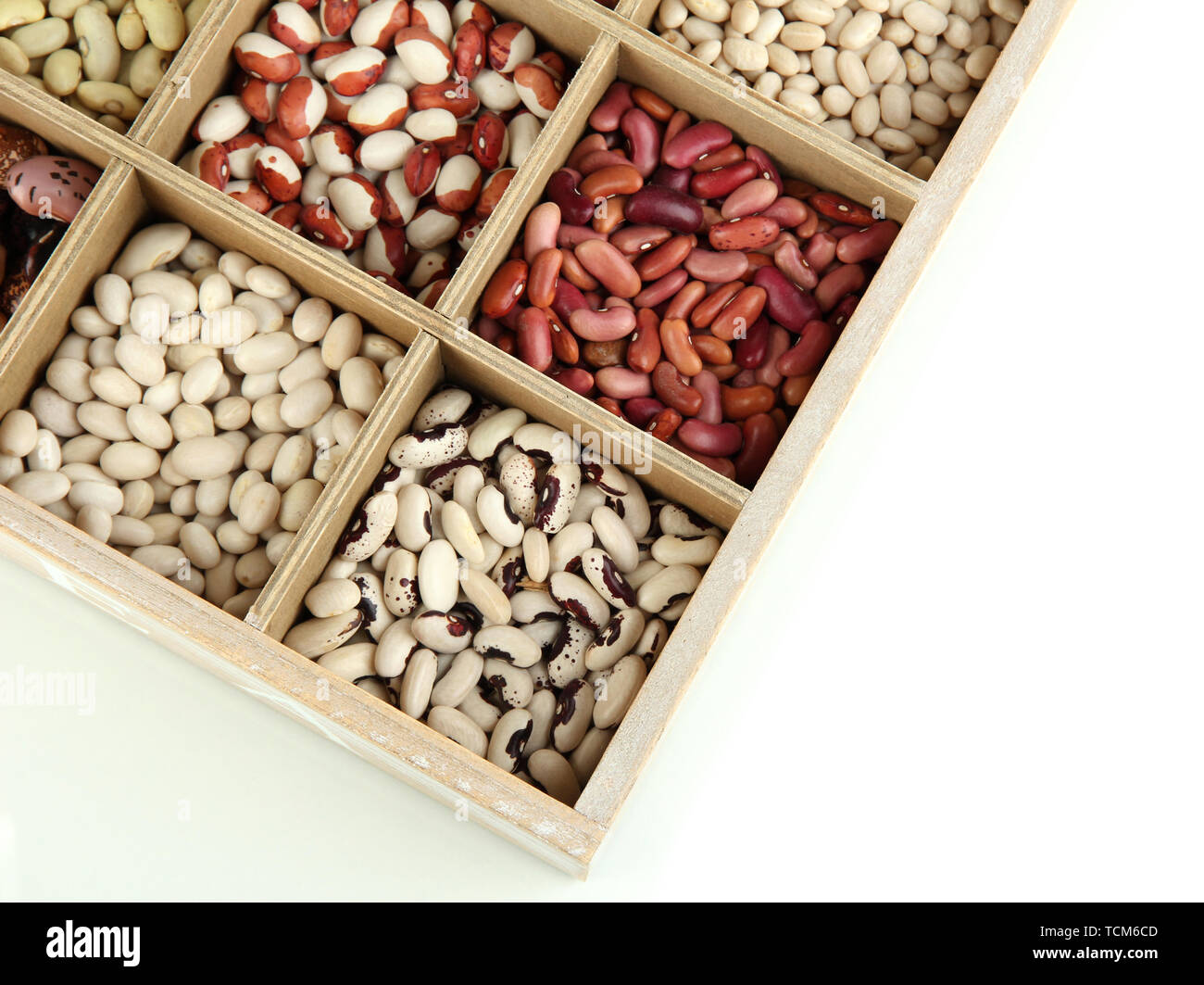 Diverse beans in wooden box sections isolated on white Stock Photo - Alamy