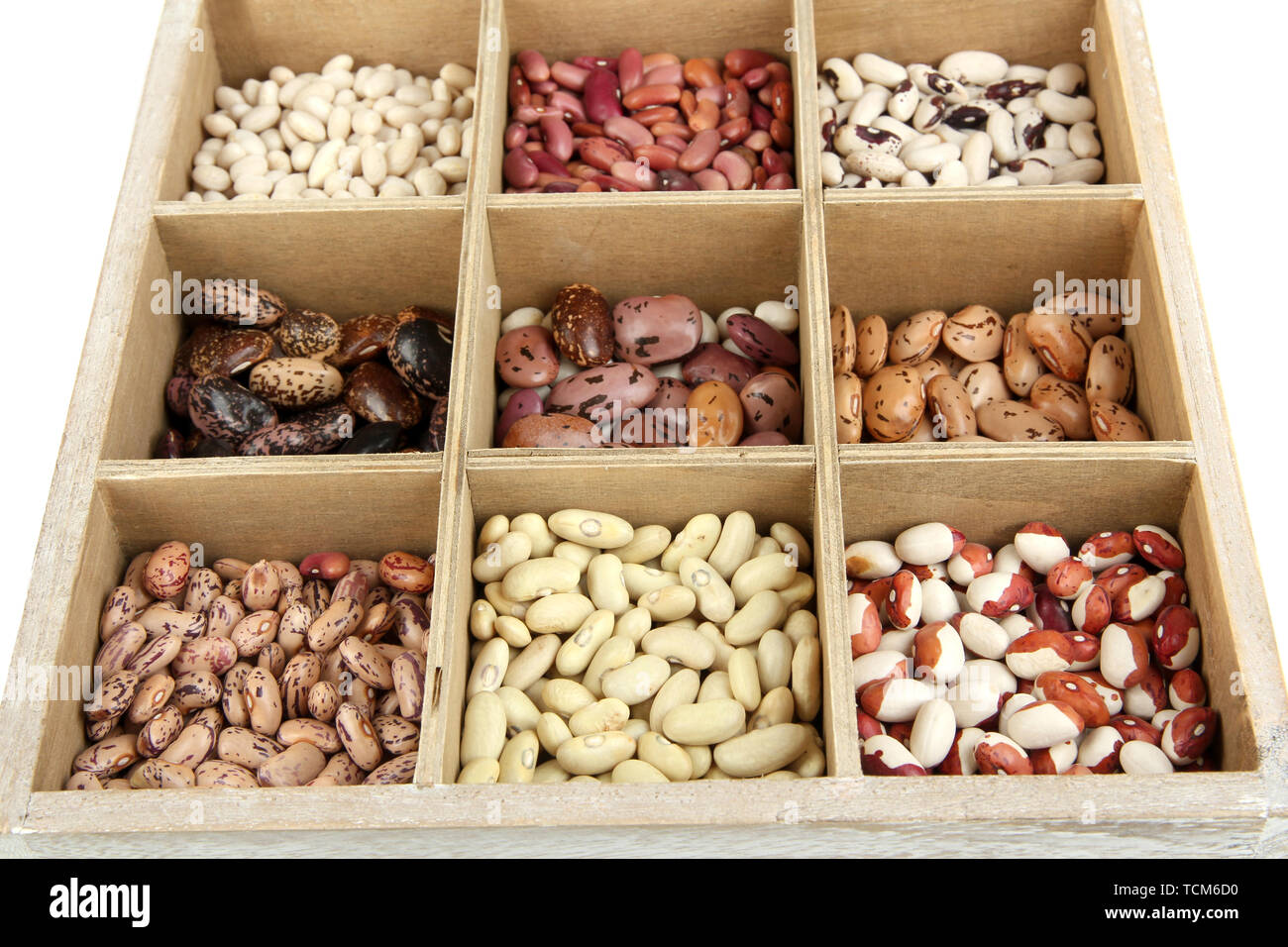 Diverse beans in wooden box sections isolated on white Stock Photo - Alamy