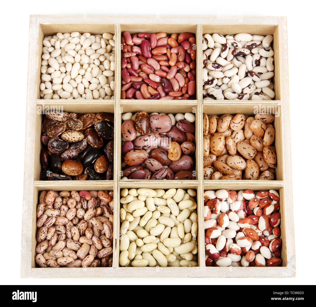Diverse beans in wooden box sections isolated on white Stock Photo - Alamy