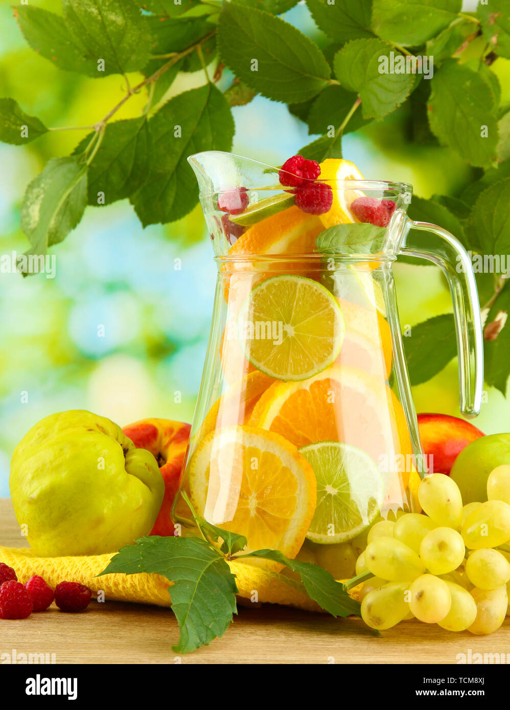 jar with citrus fruits and raspberries, on green background Stock Photo ...