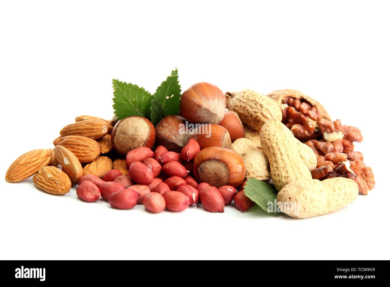 assortment of tasty nuts with leaves, isolated on white Stock Photo - Alamy