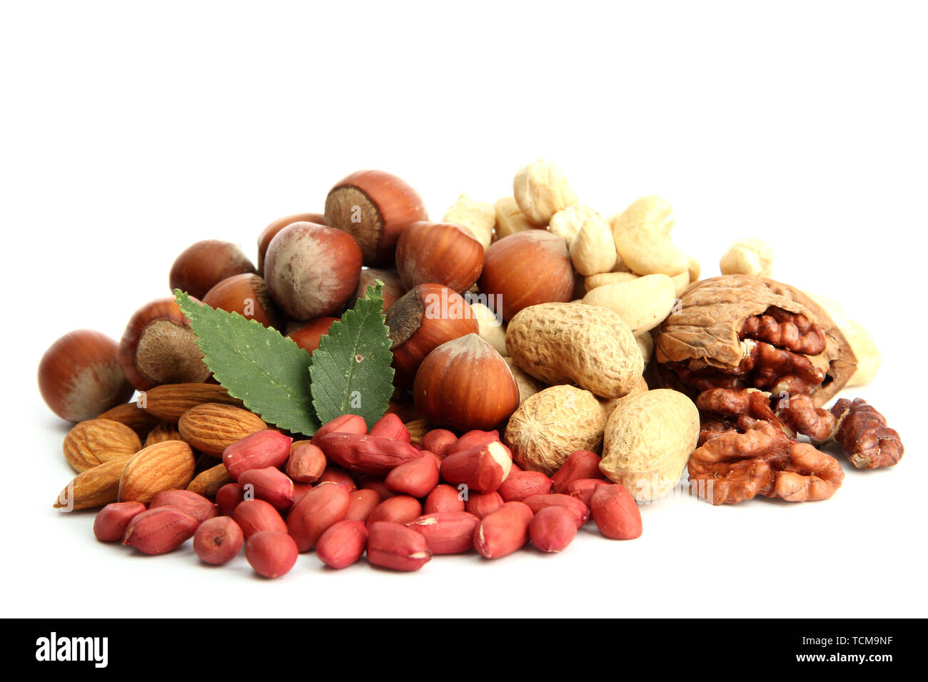 assortment of tasty nuts with leaves, isolated on white Stock Photo - Alamy