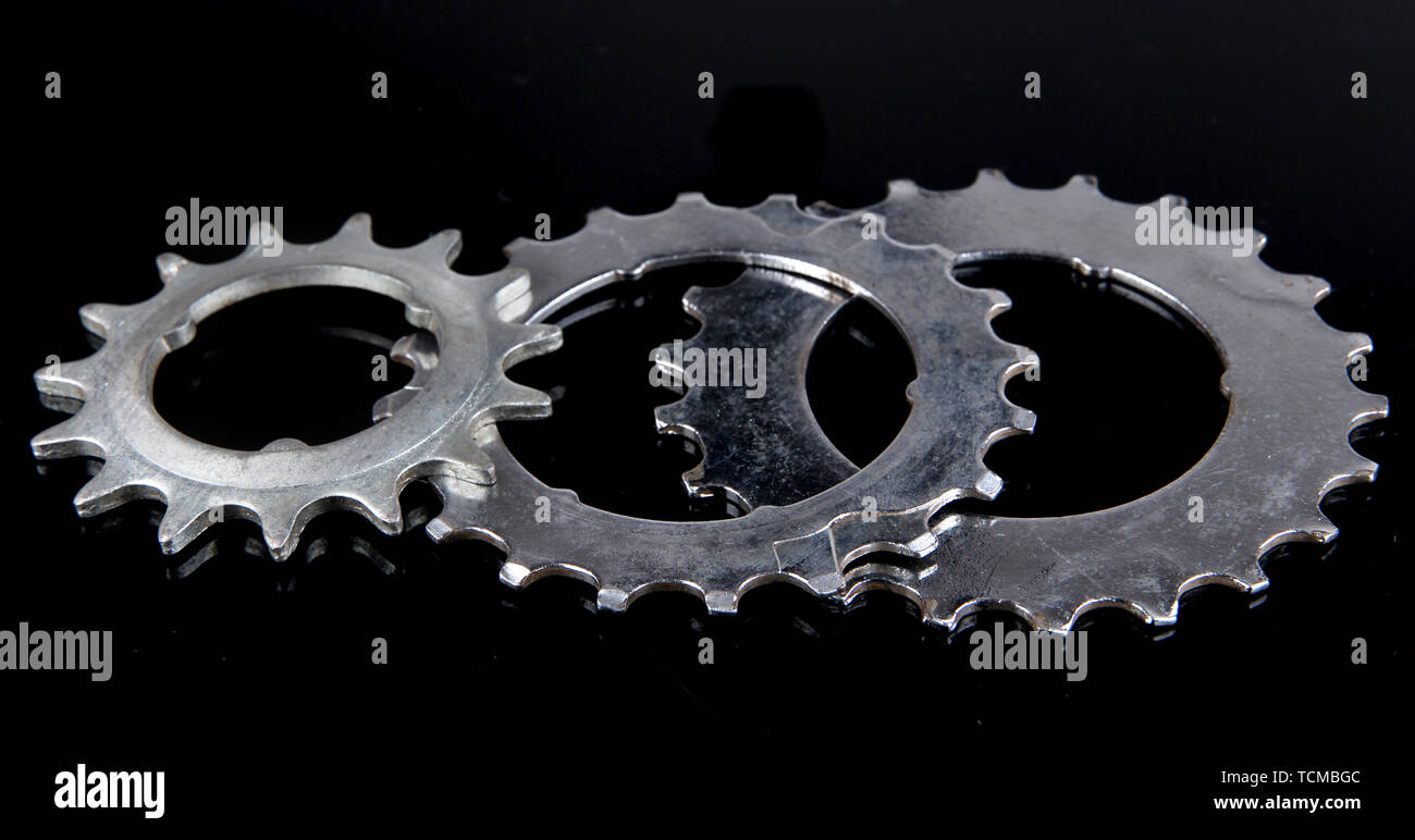 Metal cogwheels on black background Stock Photo - Alamy