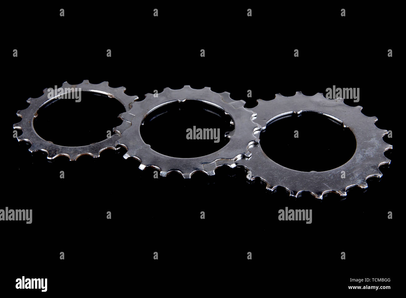 Metal cogwheels on black background Stock Photo - Alamy