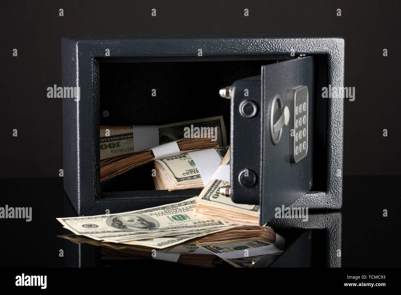 Money in open safe isolated on black Stock Photo - Alamy