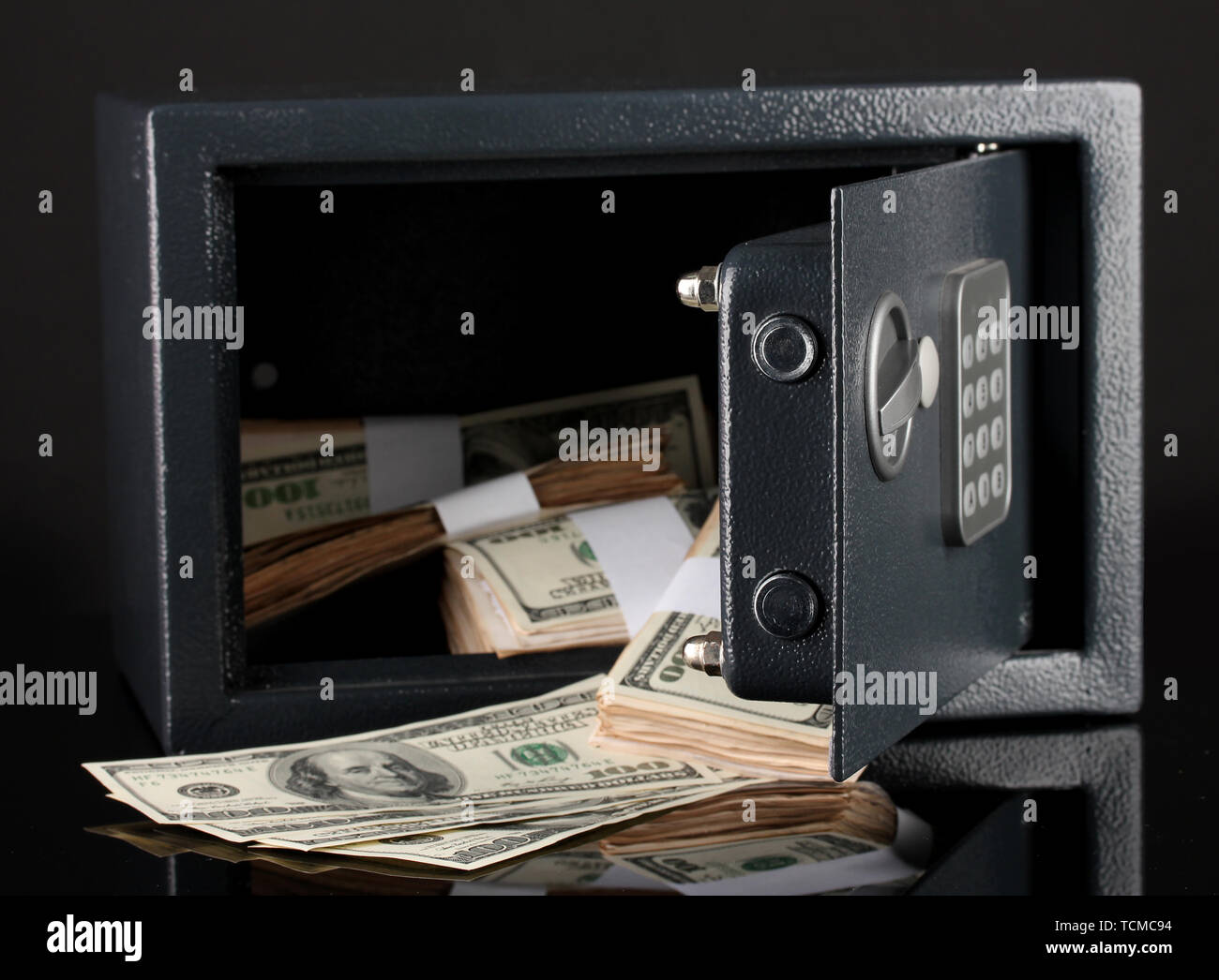 Money in open safe isolated on black Stock Photo - Alamy