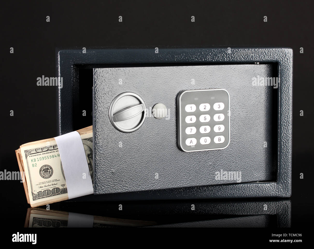Money in open safe isolated on black Stock Photo - Alamy