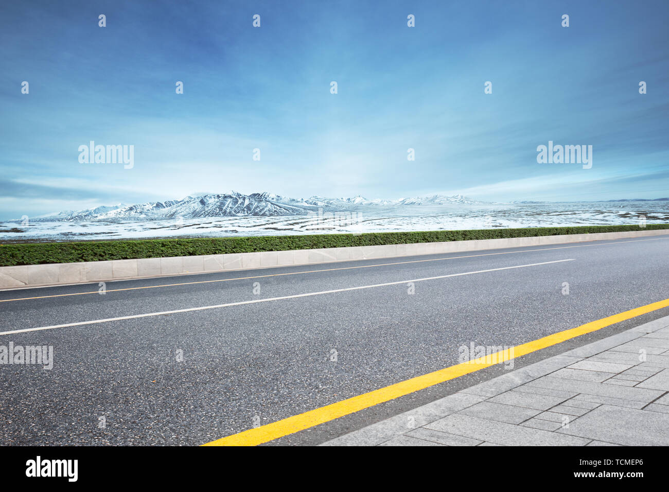 empty asphalt road with snow mountains in blue sky Stock Photo - Alamy