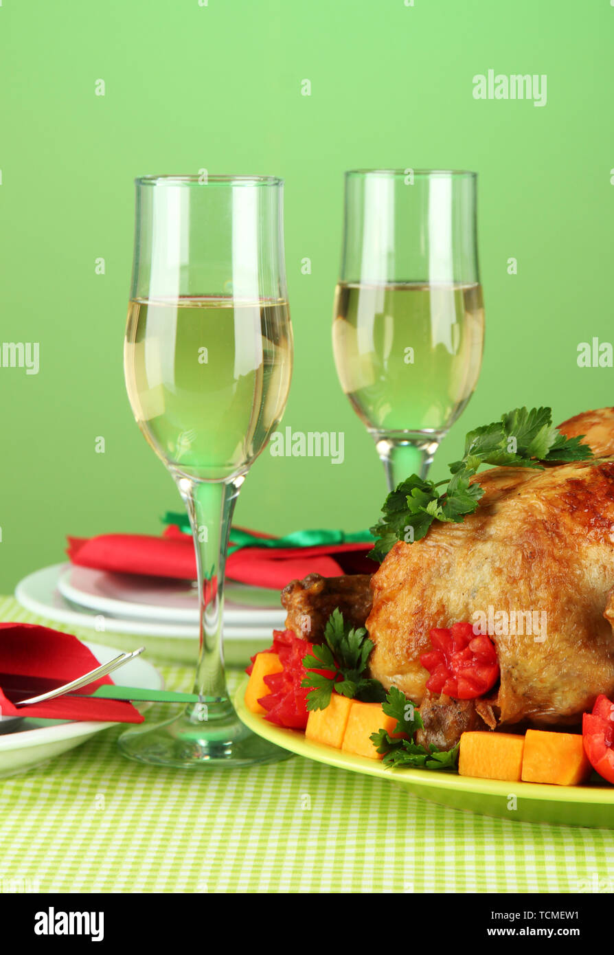 banquet table with roast chicken on green background close-up ...
