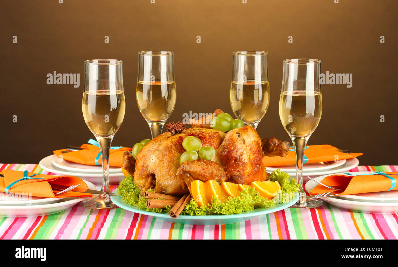 banquet table with roast chicken on brown background close-up ...