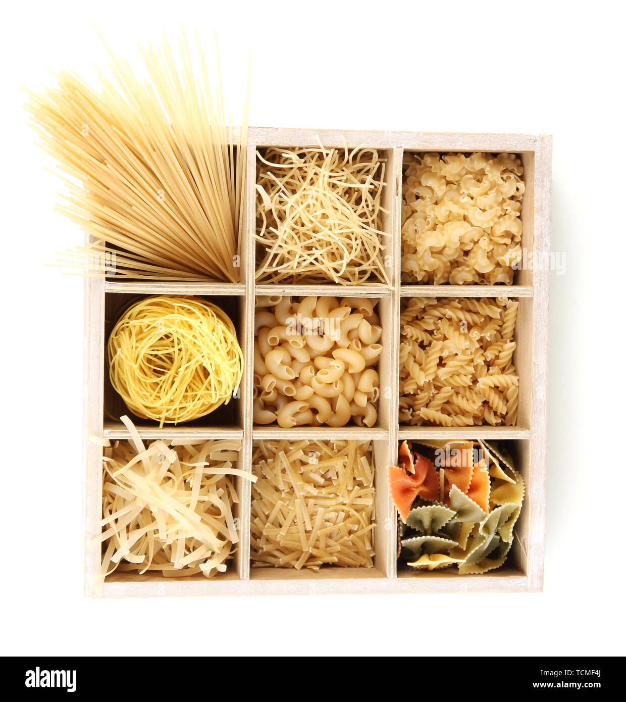 Nine types of pasta in wooden box sections isolated on white Stock ...